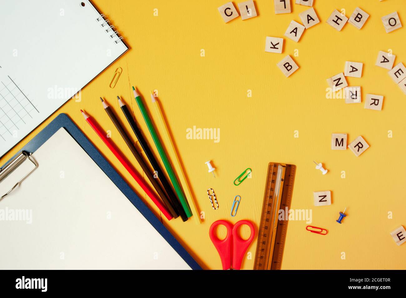 School layout, school supplies and accessories on a bright yellow ...