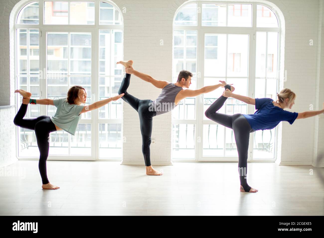 Unity of mind and body - people practicing pilates or yoga. Three ...