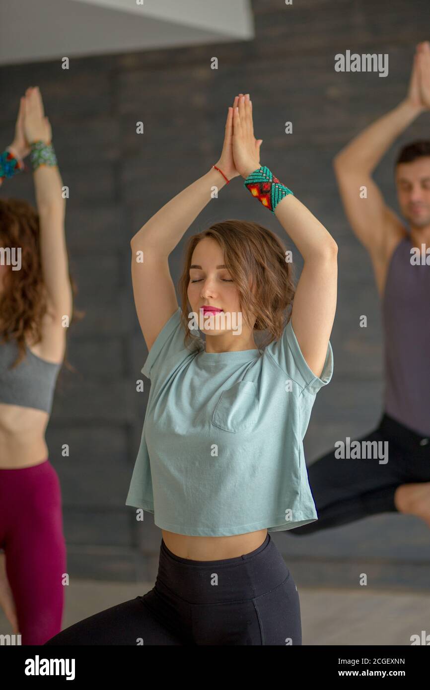Group of people engaging in his healthy hobby-practicing yoga pose ...