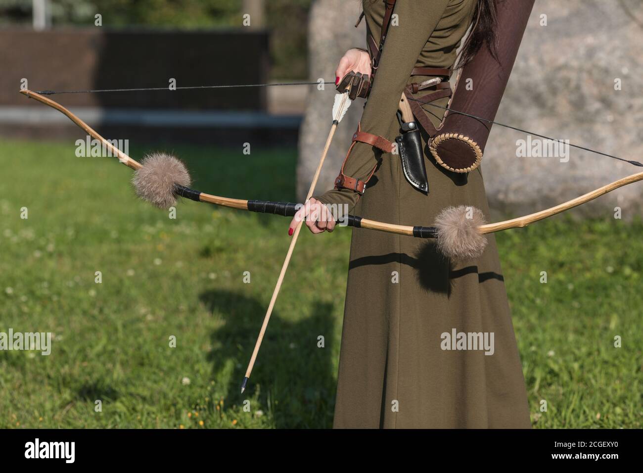 Bow and arrow in woman hands close-up Stock Photo - Alamy