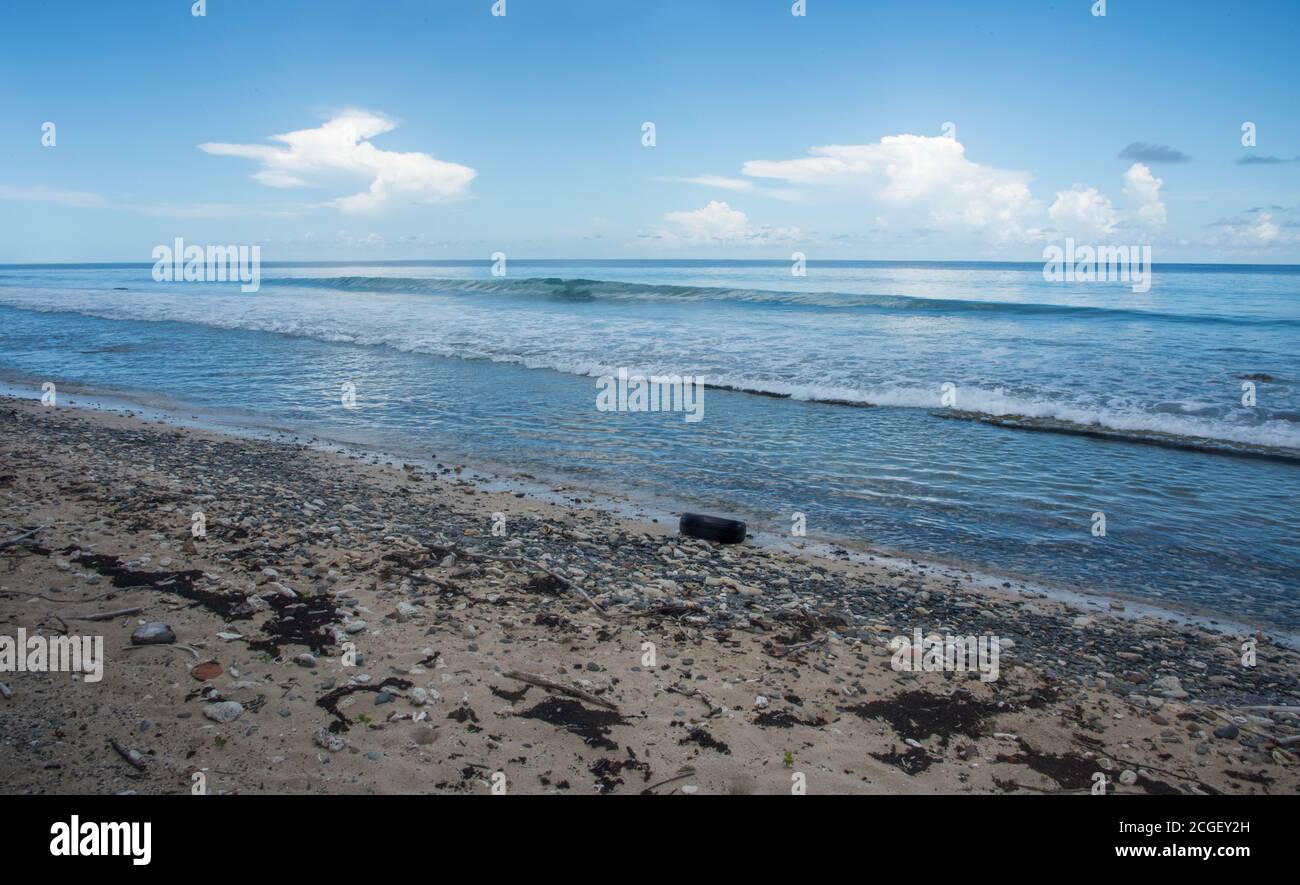 Caribbean Sea waves flowing into a Frederiksted Beach under a blue sky ...