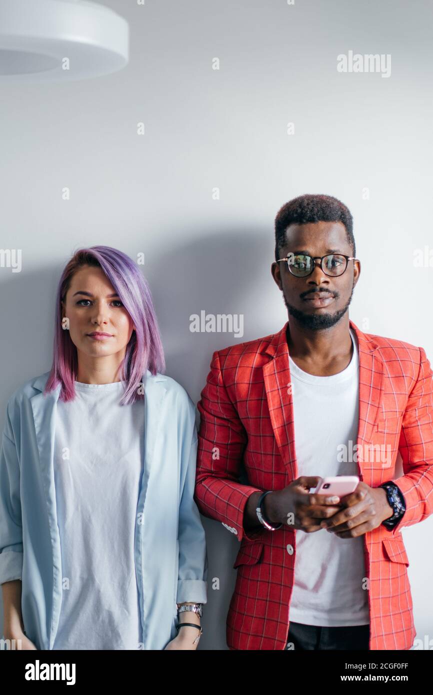 Portrait of serious no emotion face multiracial couple isolated over ...