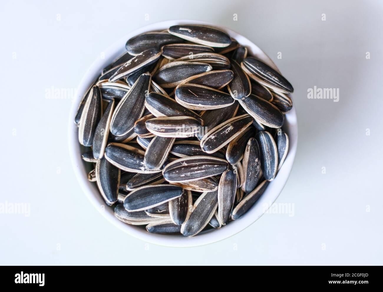 Sunflower seed snack or kuaci on plate on white background Stock Photo ...