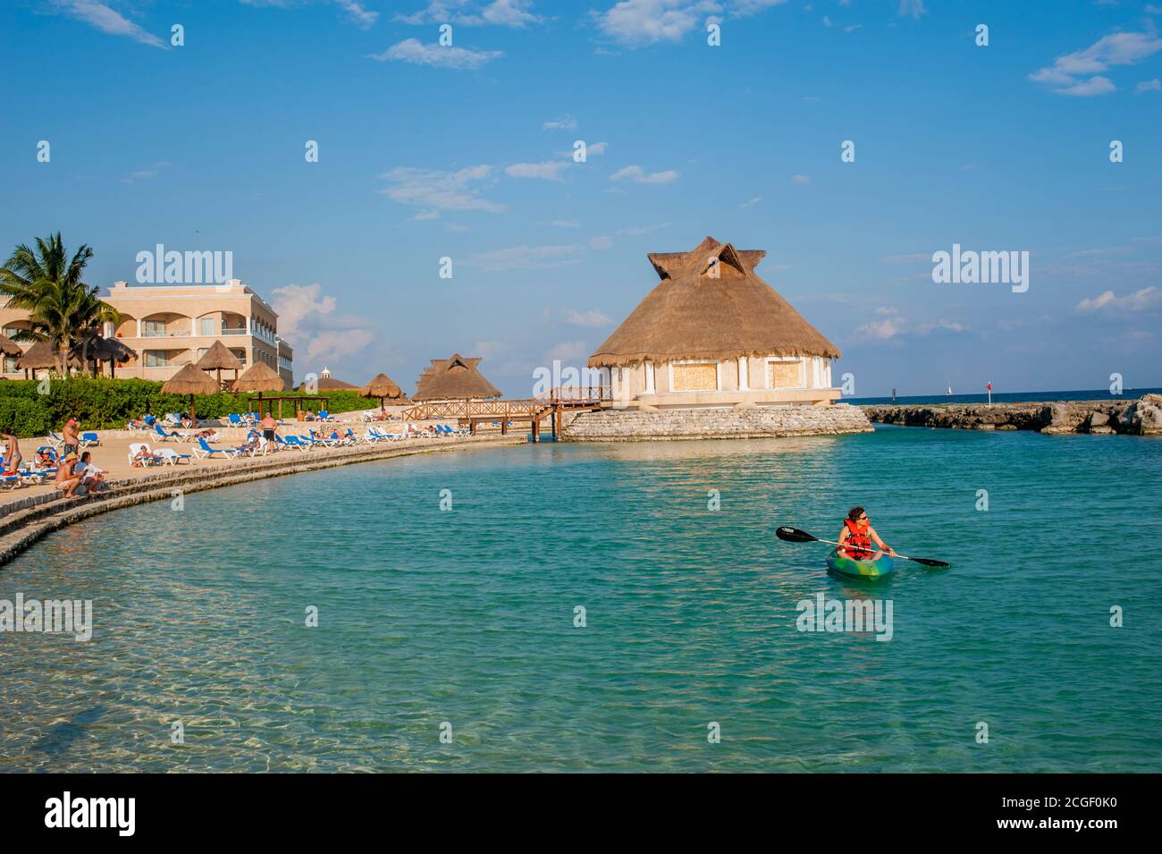A woman (model released) is kayaking at the Hard Rock Riviera Maya ...