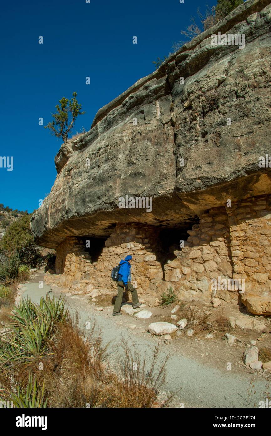 A tourist (model released) at the Sinagua cliff dwellings from around ...