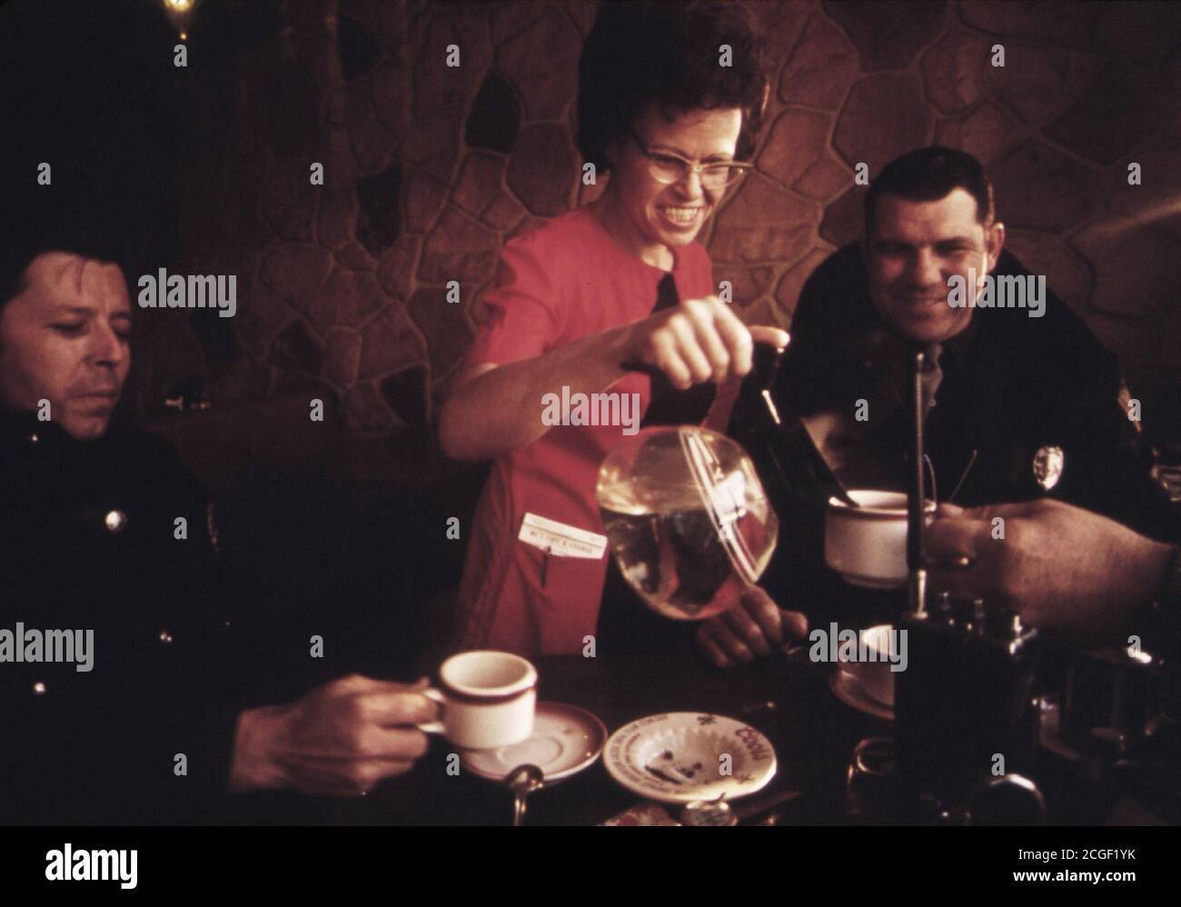 Waitress pours coffee for police officers in a cafe in Rifle, Colorado ...