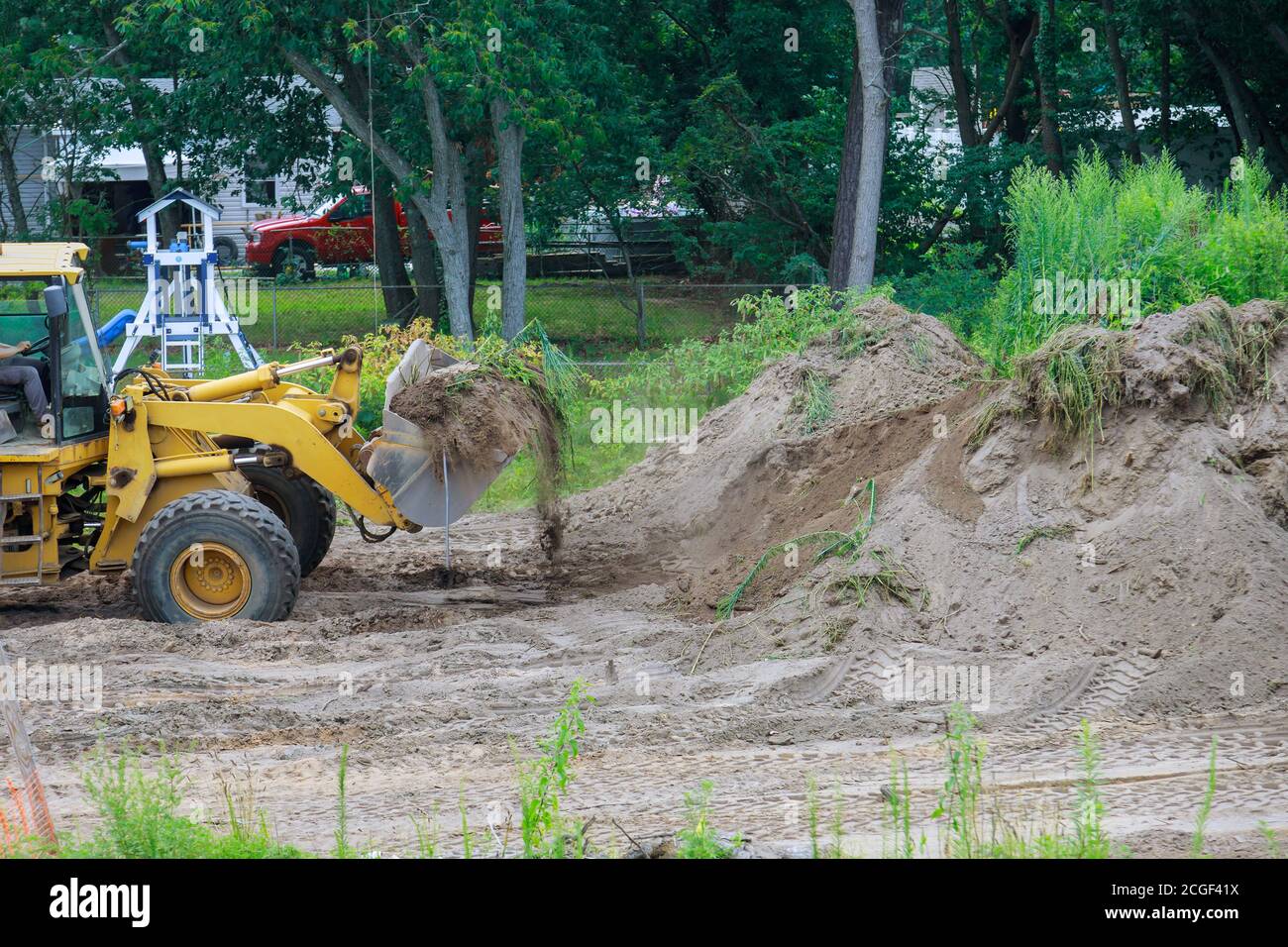 Landscaping works on the bulldozer moves soil digging ground ...