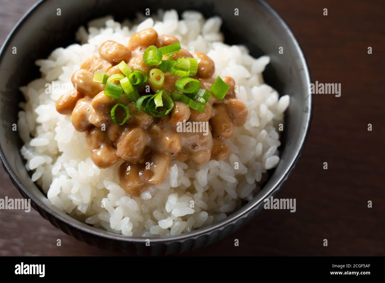 The natto put on the rice put on the background of the dark tree. Image ...