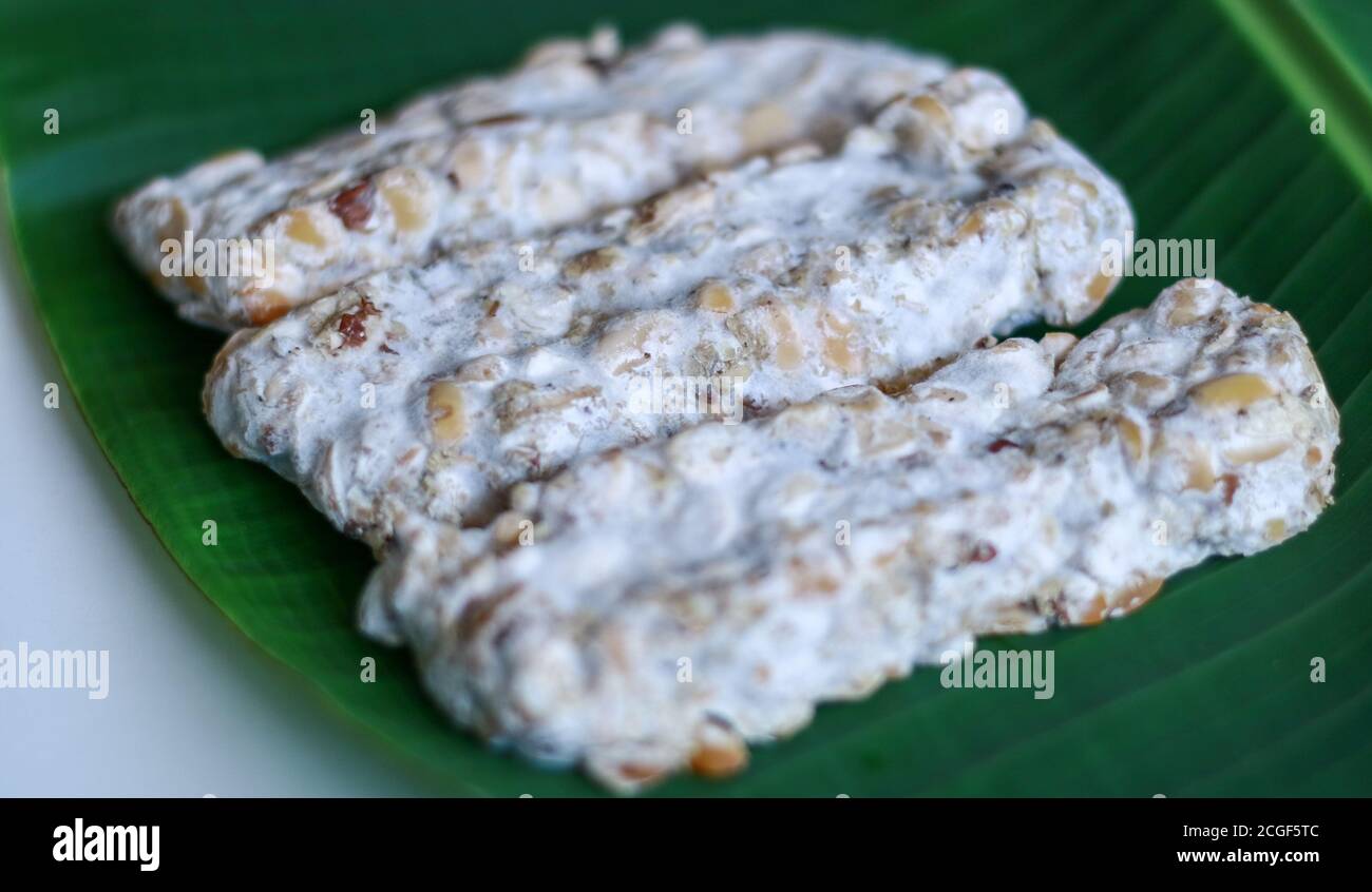 Black oncom on banana leaf background. Oncom is one of the traditional ...