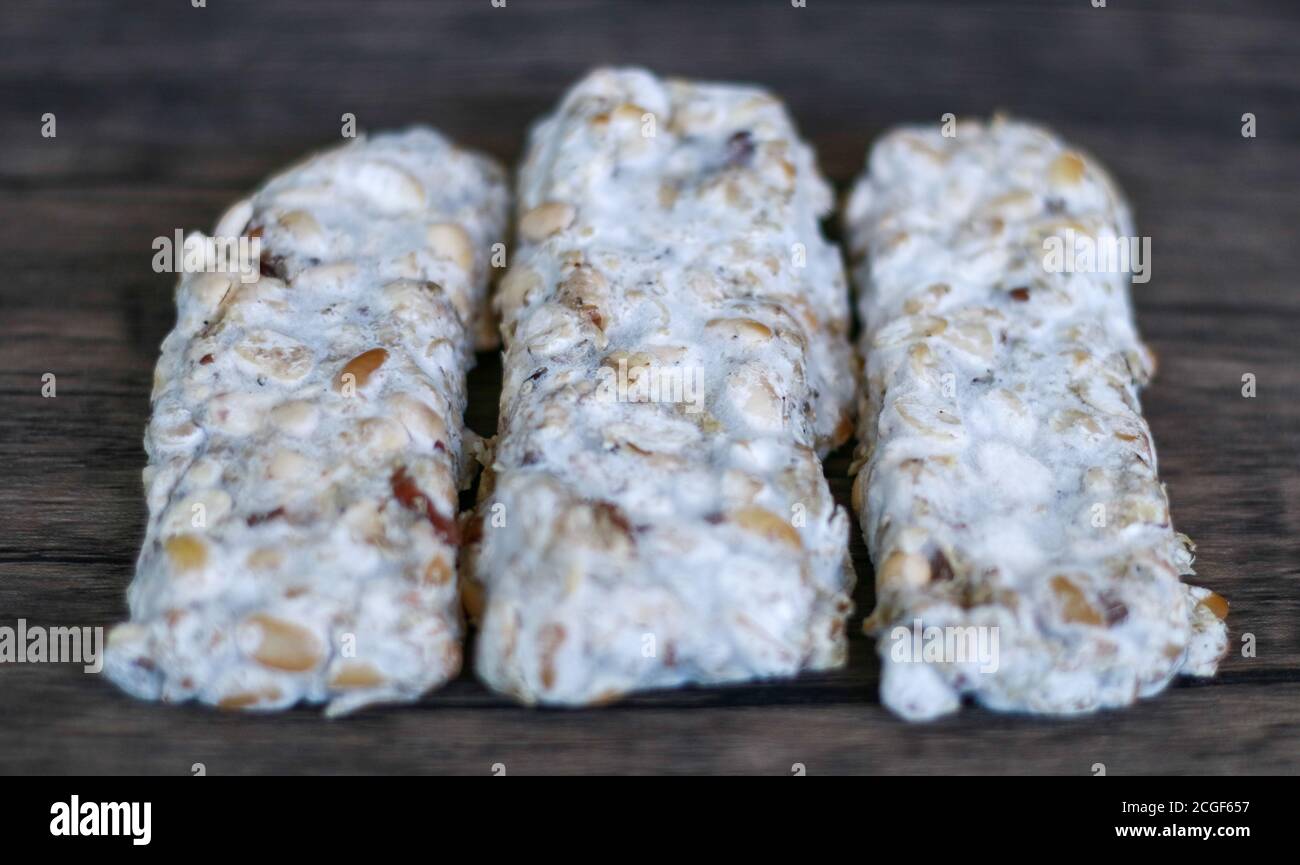 Black oncom on wood background. Oncom is one of the traditional staple ...