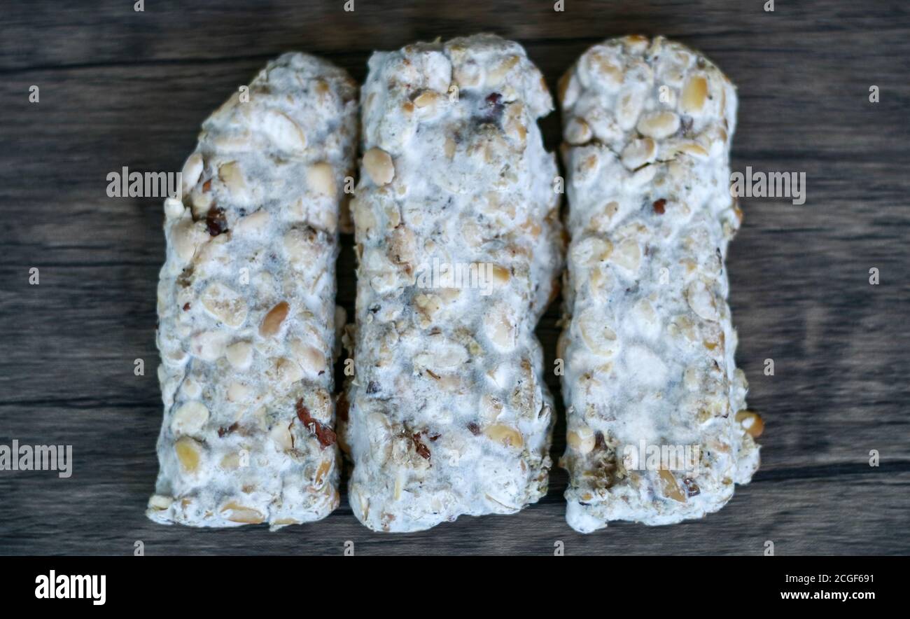 Black oncom on wood background. Oncom is one of the traditional staple ...