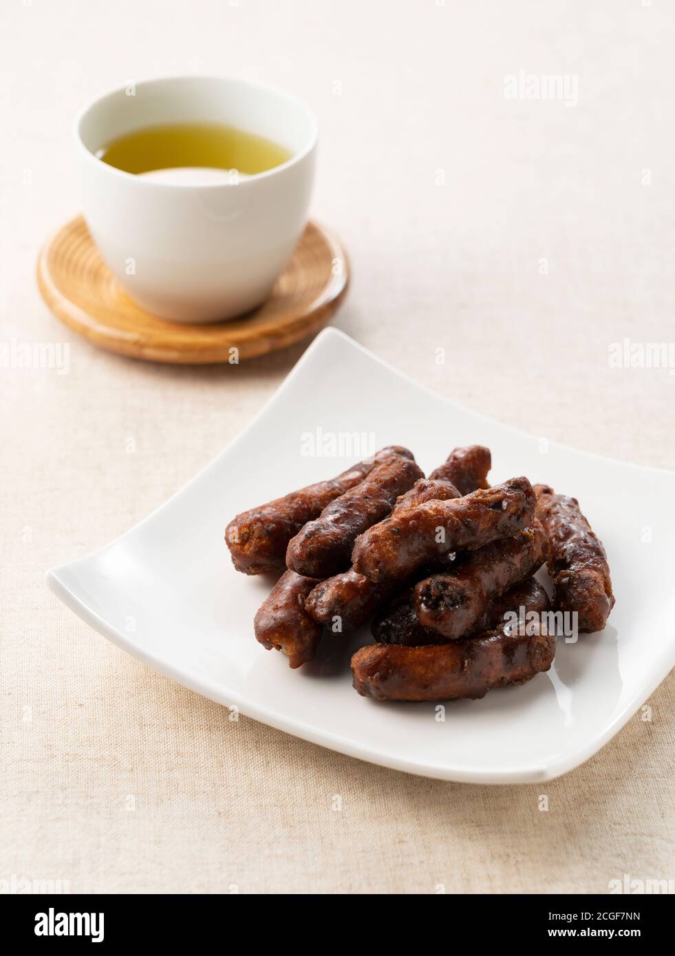Green tea and karinto (Japanese sweets) on a cloth background Stock ...