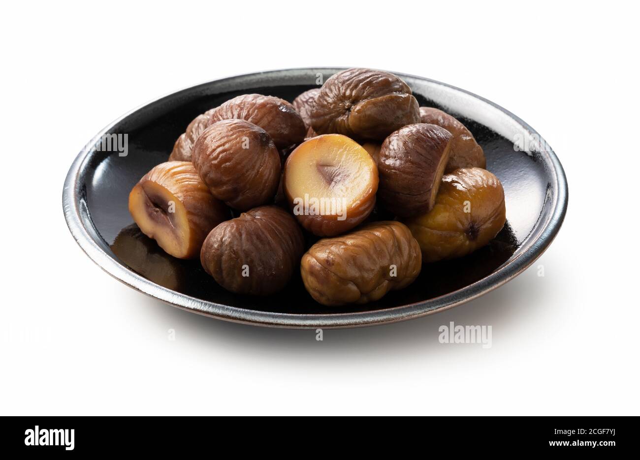Peeled sweet chestnuts in a plate on a white background Stock Photo - Alamy