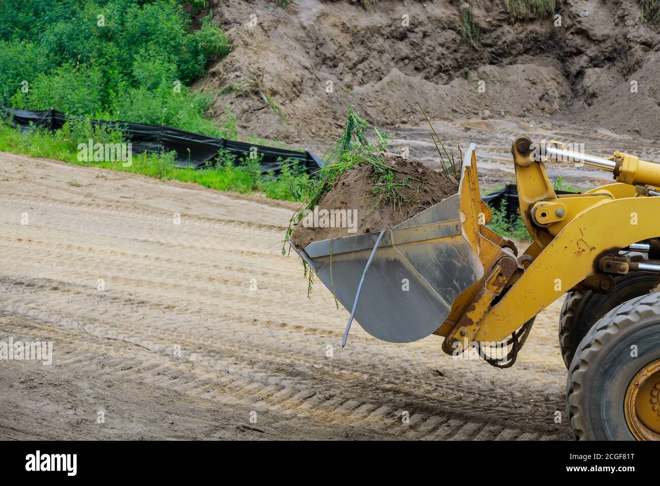 Construction bulldozer leveling and moving soil landscaping works on ...