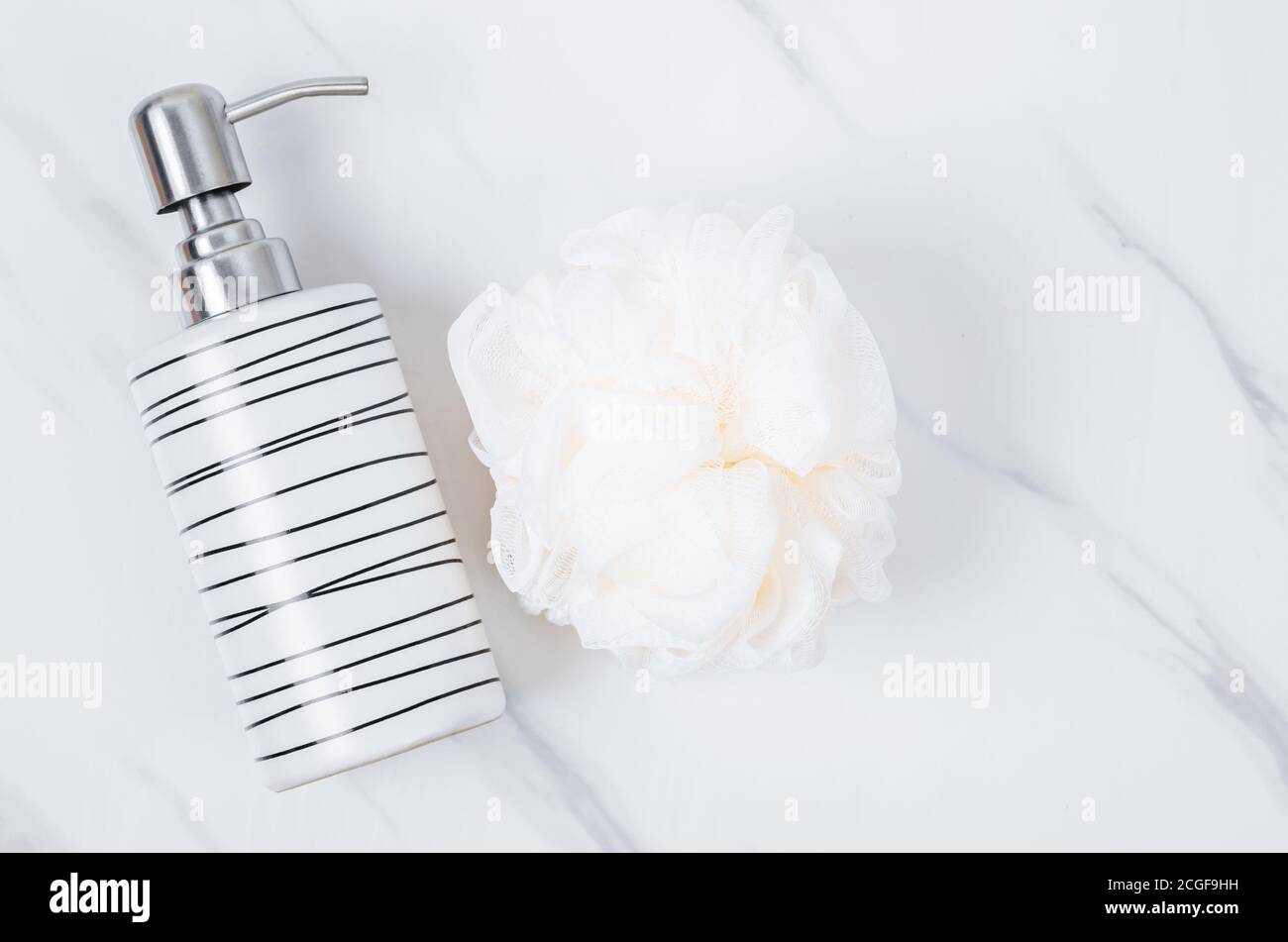 Ceramic pump bottle for liquid soap and bath sponge on marble ...