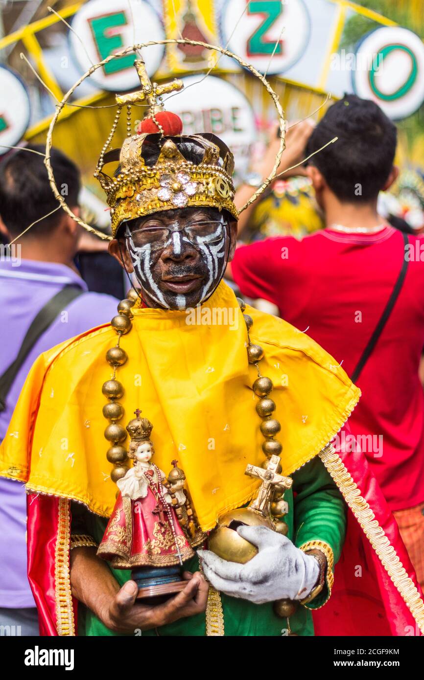 A reveler in costume during the Ati-atihan Festival in Kalibo, Aklan ...