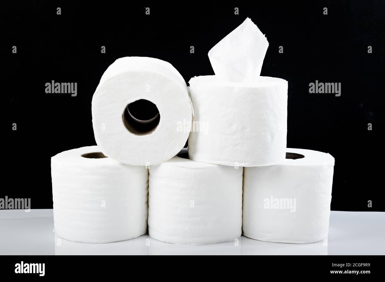 Tissue paper rolls on the black background Stock Photo - Alamy