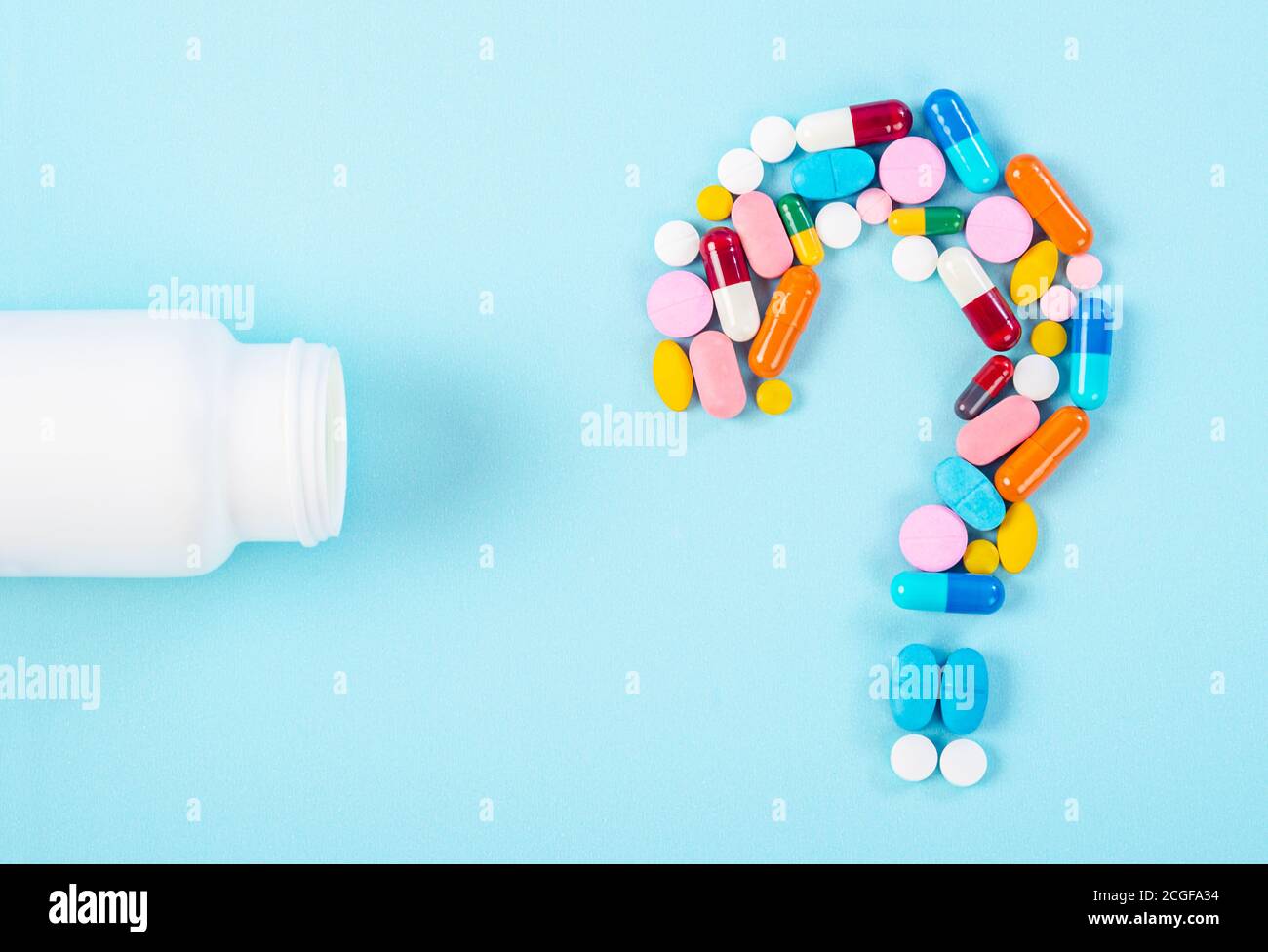 A question mark from laid out of medicine pills with bottle drug on ...