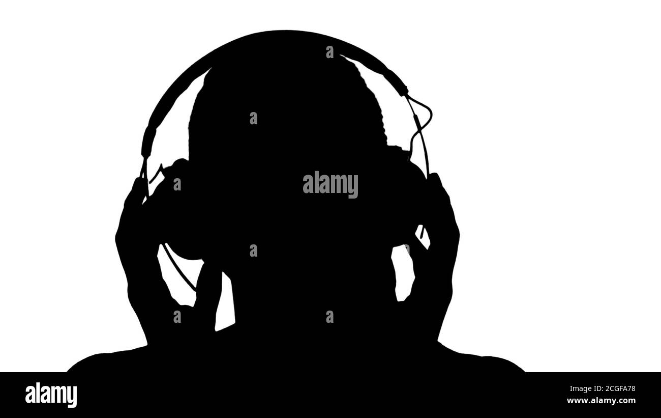 Silhouette Charming woman smiling while listening to music in ...