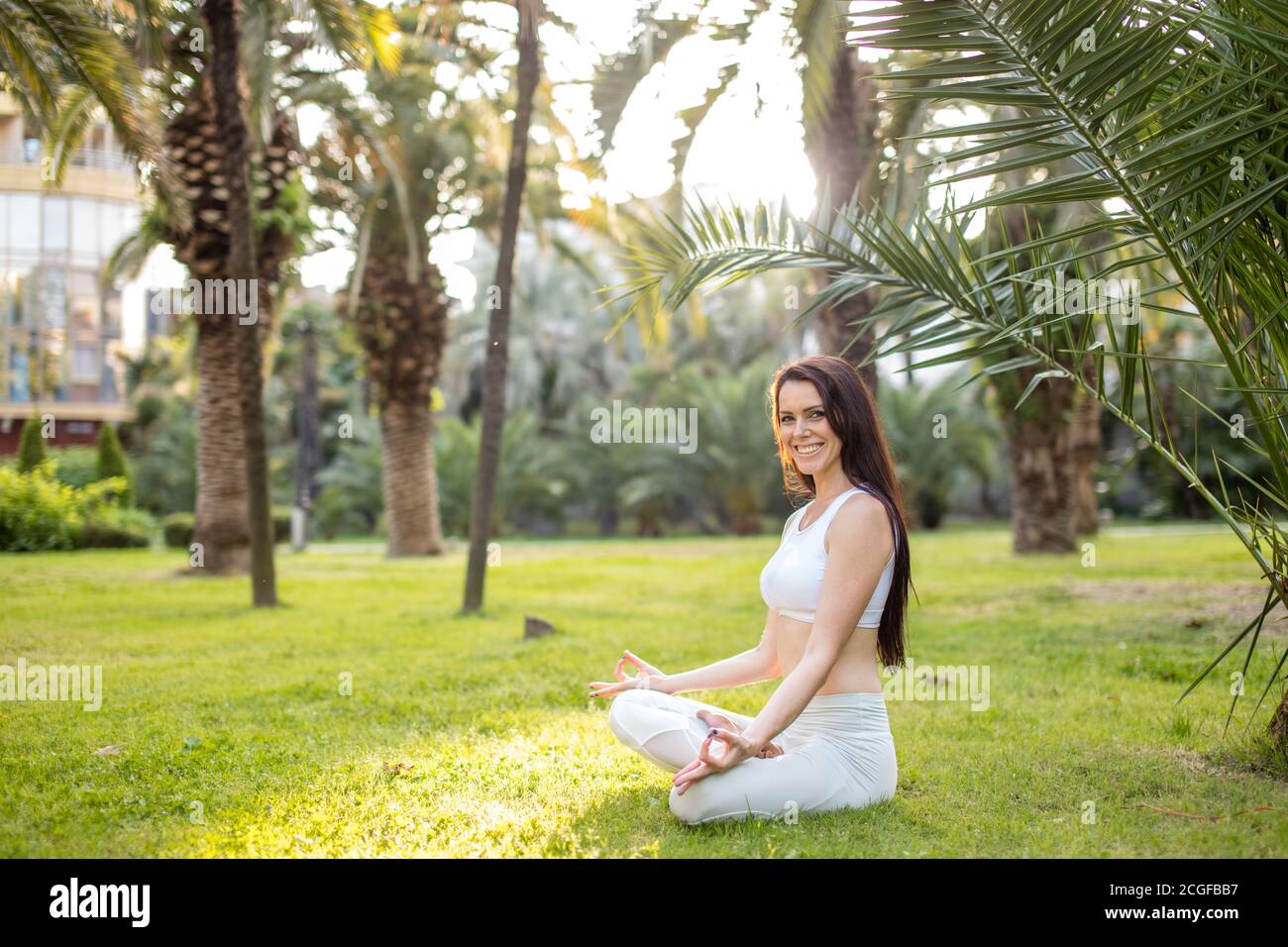 Cool attractive yogi woman practicing yoga concept, sitting in Lotus ...