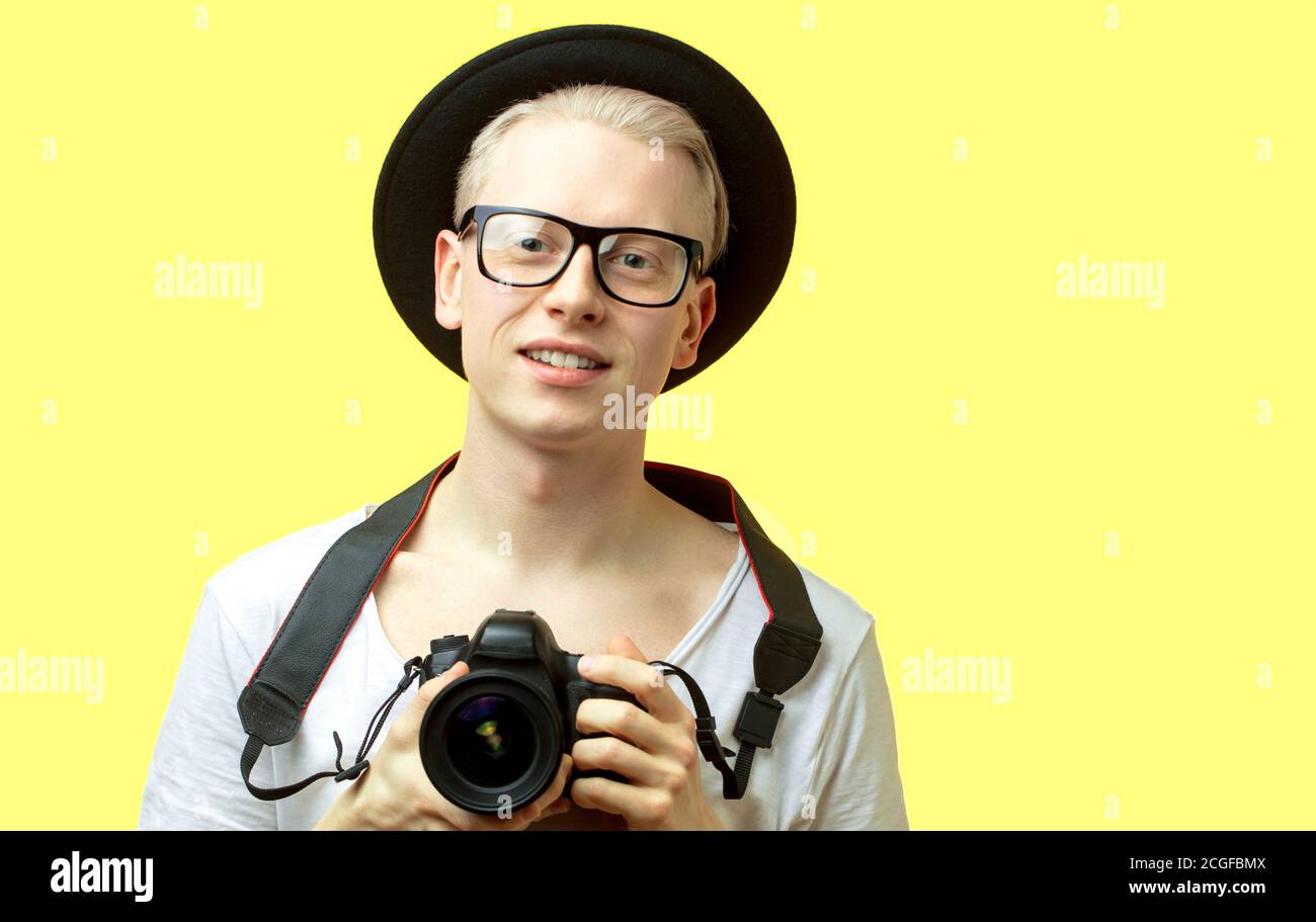 Half-length portrait of young handsome albino man tourist wearing black ...