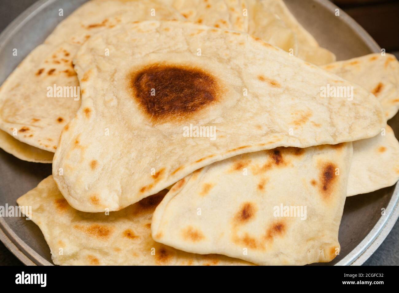 Puffed Indian bread puri on frying pan Stock Photo - Alamy