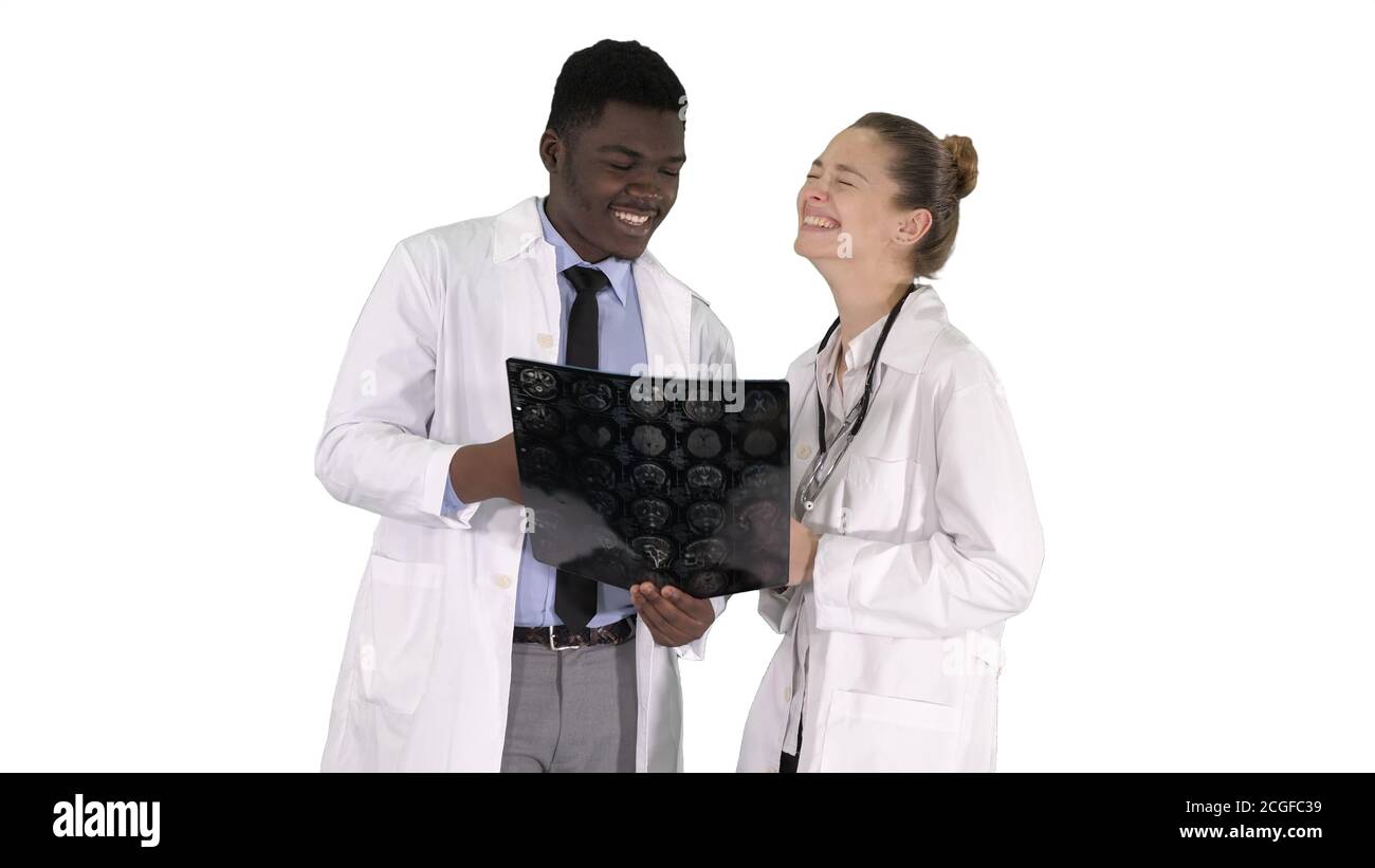 Laughing doctors studying X-ray on white background Stock Photo - Alamy