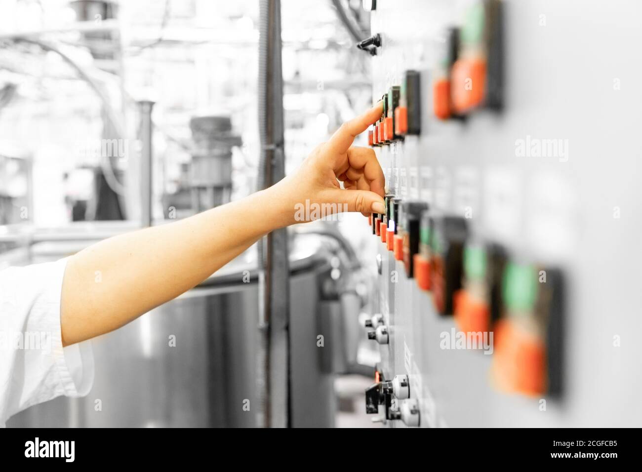 Worker controls automatic machines and production, finger presses ...