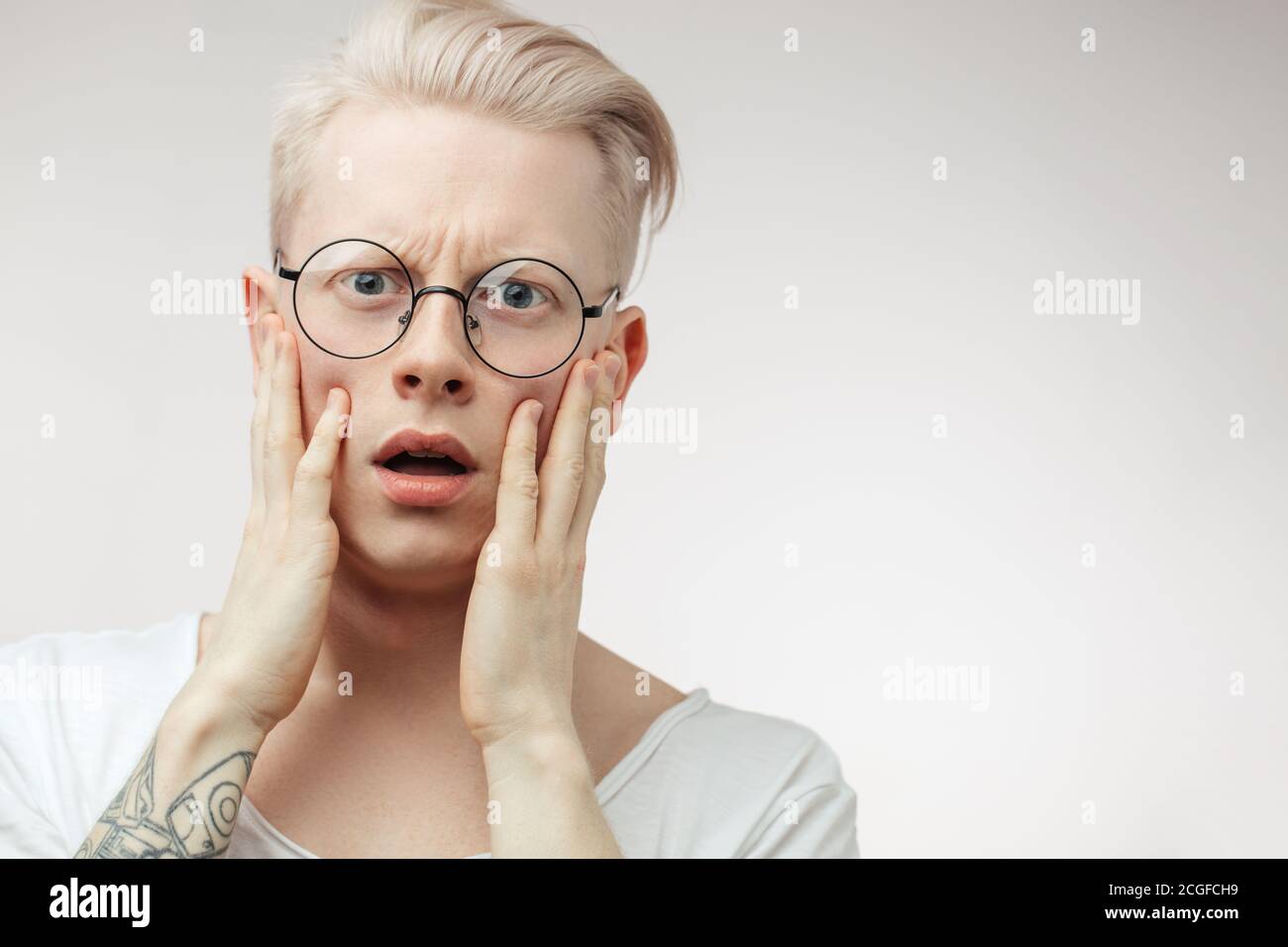 upset blonde man trembling with fear, being shocked and horrified ...