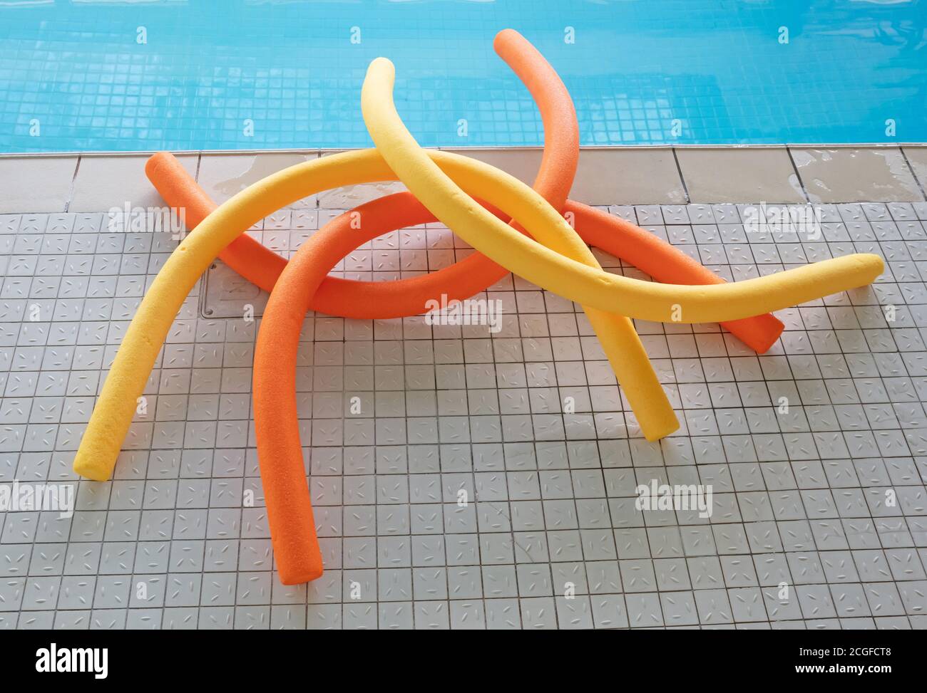 Aqua noodles next to a indoor swimming pool, selective focus Stock ...
