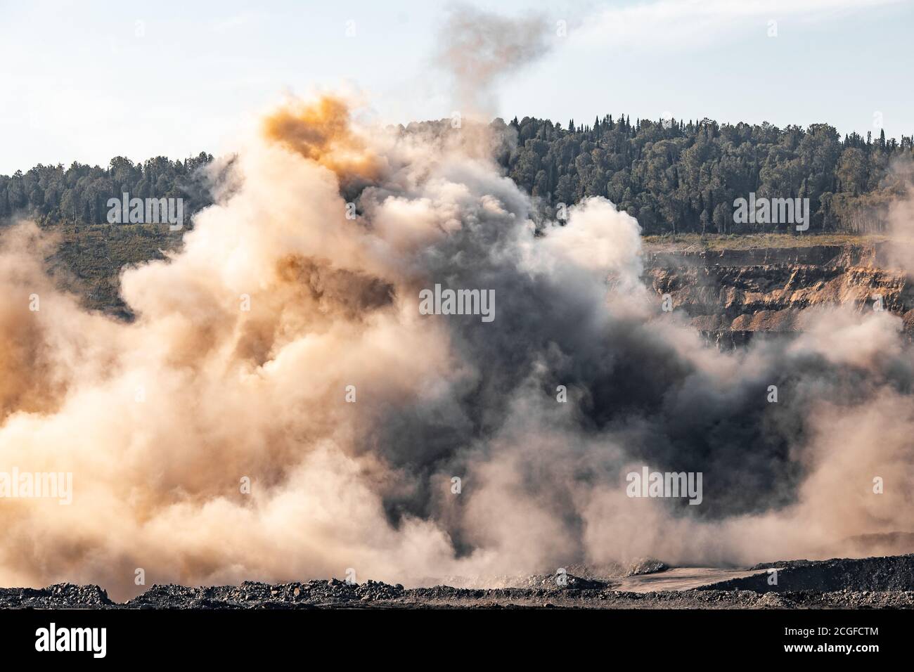 Explosive works on open pit coal mine industry. Dust and puffs of smoke ...