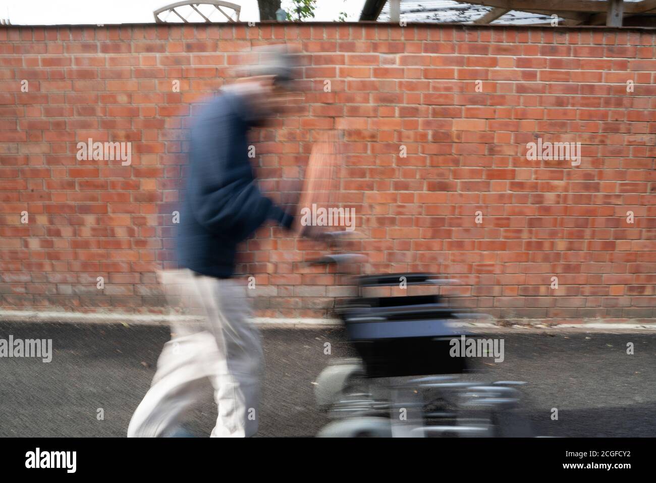 Old man pushing wheelchair hi-res stock photography and images - Alamy