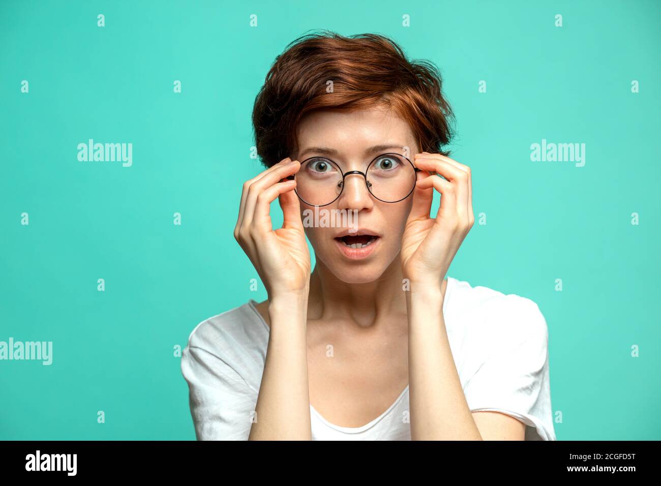 Surprised Excited Scared Ginger Woman Holding Hands Near Eyes With Spectacles Open Mouth