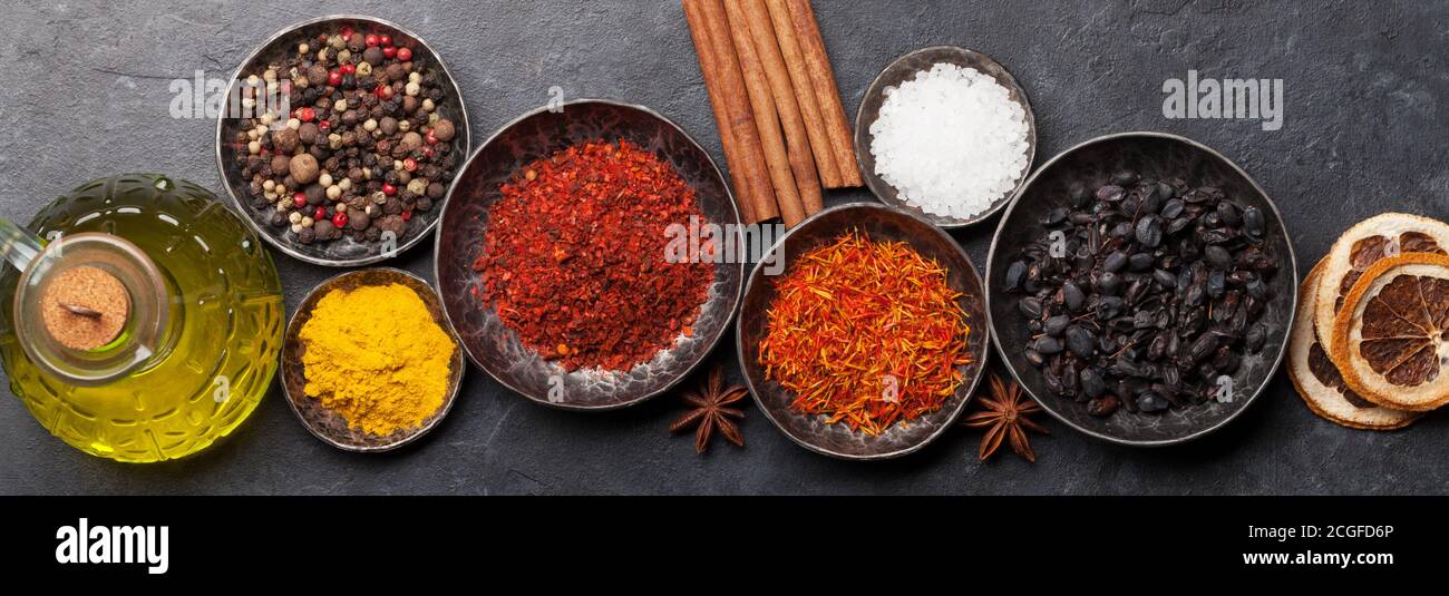 Various spices in bowls on dark stone table. Indian cuisine. Top view ...