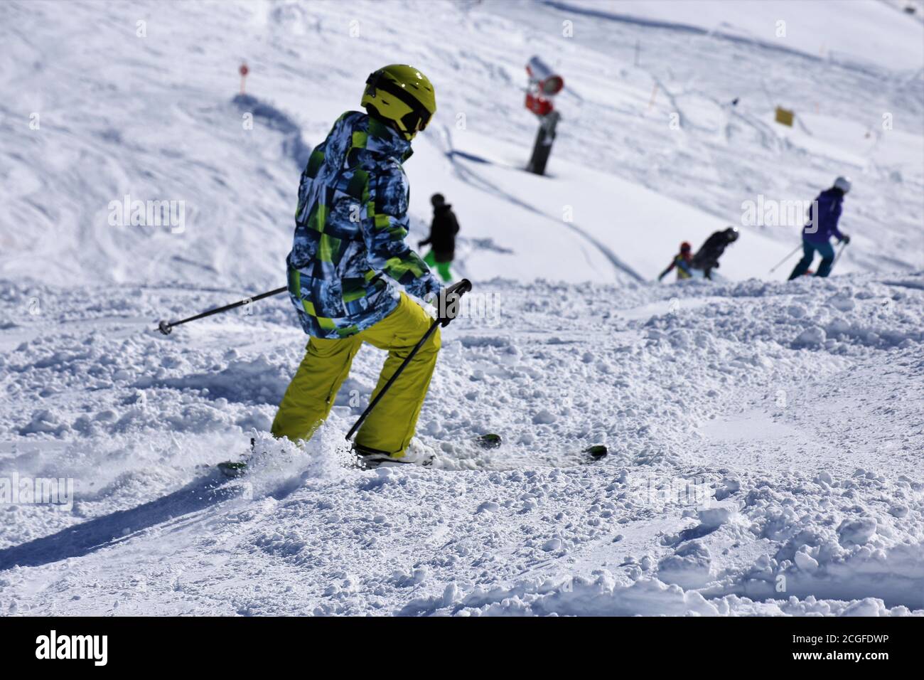 Sporty skier riding the slope Stock Photo - Alamy