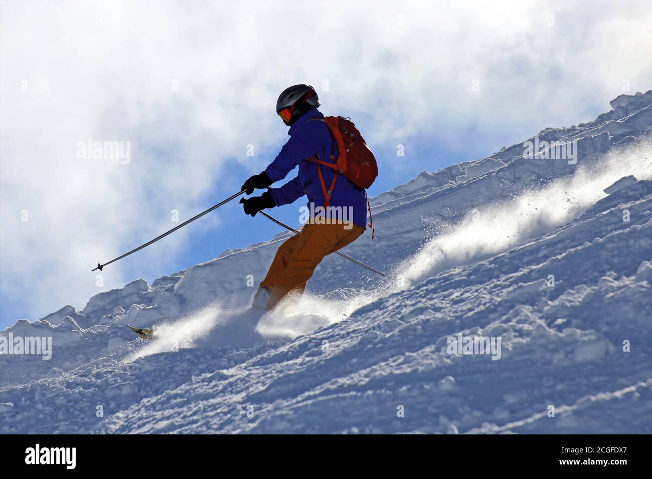 Sporty skier riding the slope Stock Photo - Alamy
