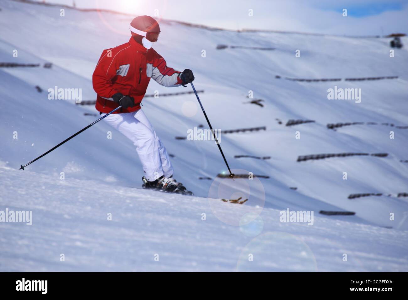 Sporty skier riding the slope Stock Photo - Alamy