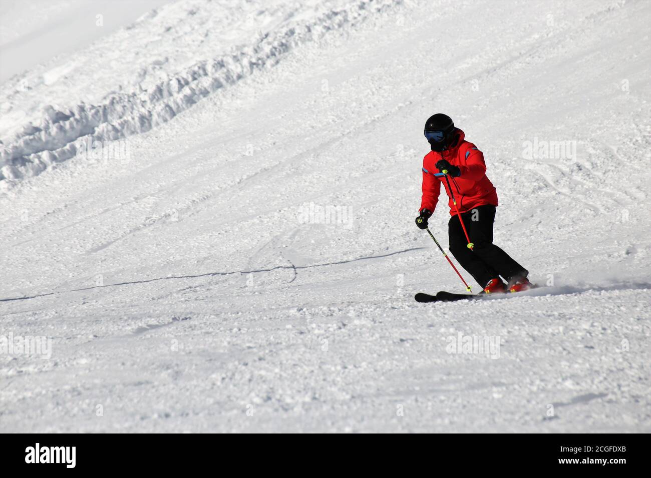 Sporty skier riding the slope Stock Photo - Alamy
