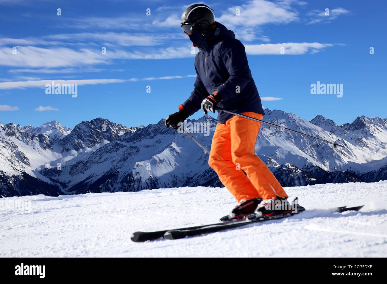 Sporty skier riding the slope Stock Photo - Alamy