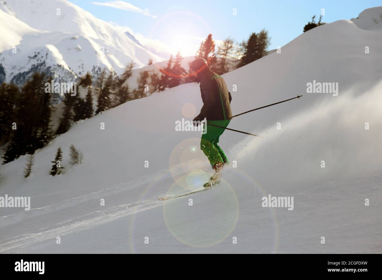 Sporty skier riding the slope Stock Photo - Alamy