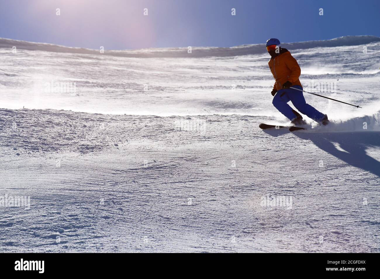Sporty skier riding the slope Stock Photo - Alamy