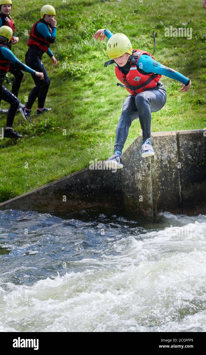 Teenage boy leaps into a stopper on the artificial whitewater course at ...