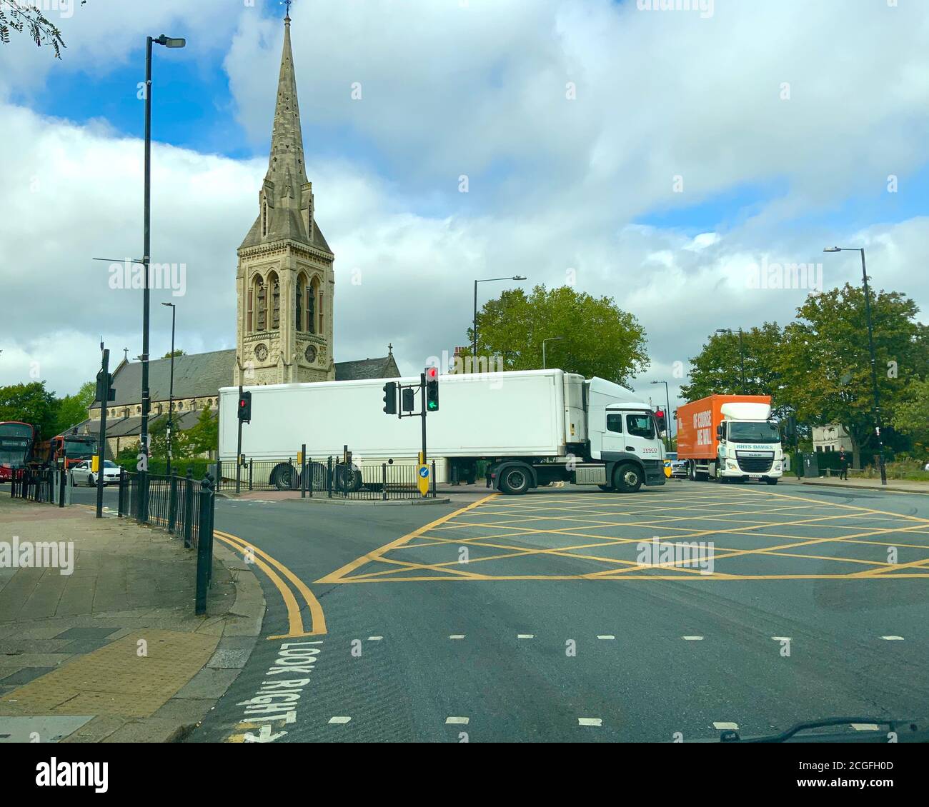 White lorry crossing a junction of busy road in London, United Kingdom ...