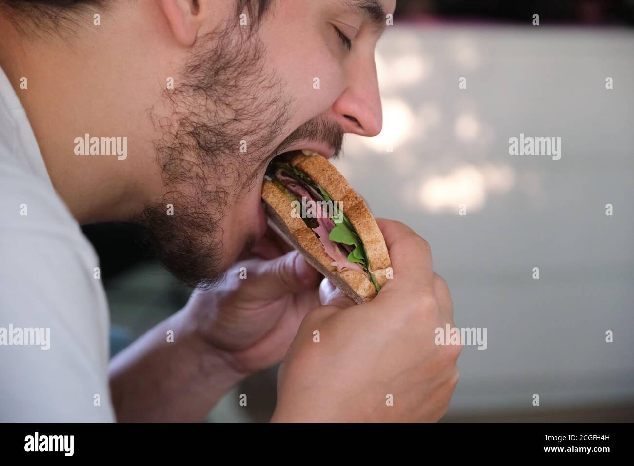 Man biting sandwich hi-res stock photography and images - Alamy