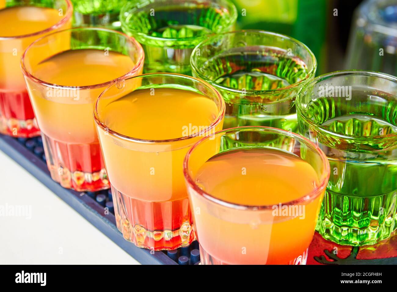 Several multicolored alcoholic drinks shots on the bar counter Stock ...