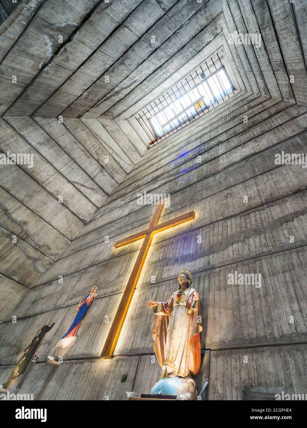 Looking up the chimney-like tower,from the altar,crucifix and statue of ...