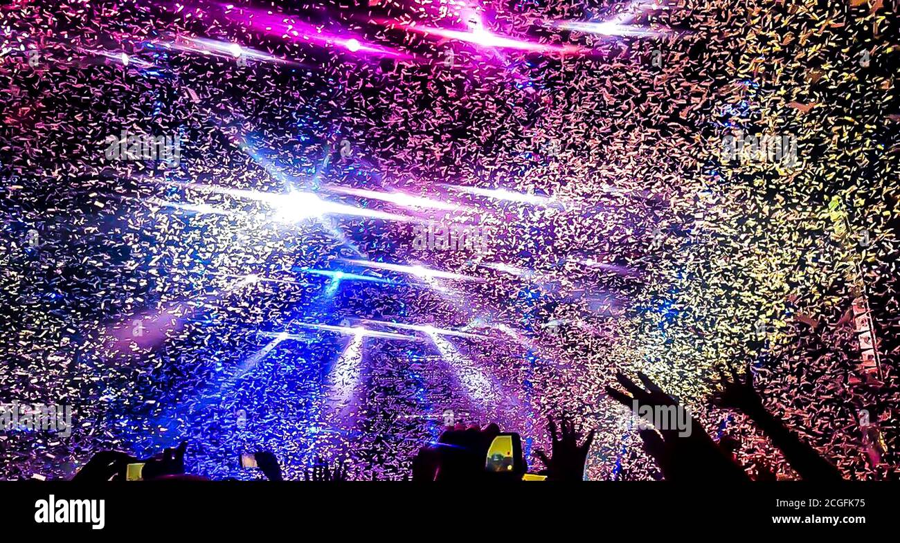 Bright and colorful laser rays and confetti Stock Photo - Alamy