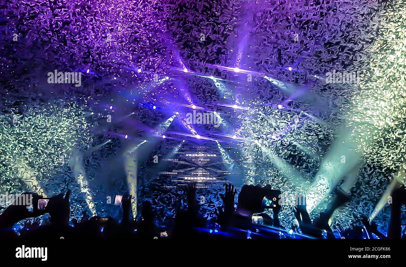 Bright and colorful laser rays and confetti Stock Photo - Alamy