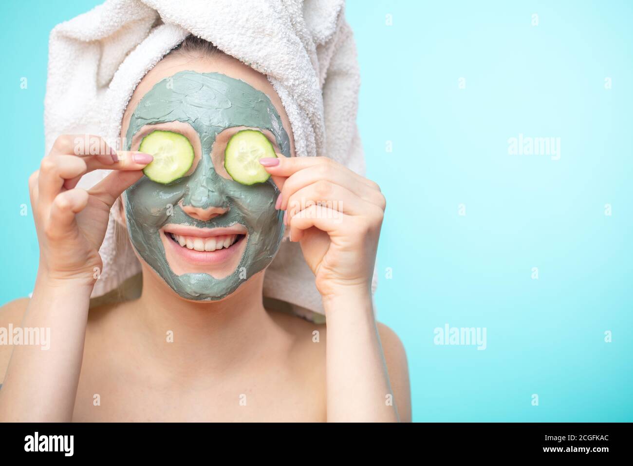 Young women with facial masks and cucumber slices in spa salon Stock ...