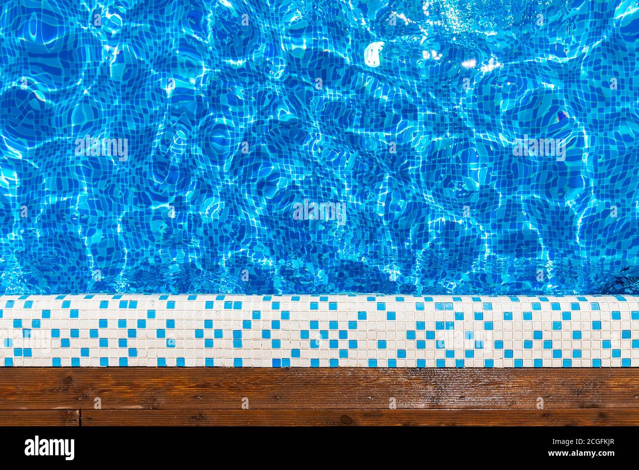 Top view blue swimming pool with teak wood flooring stripes sunlight ...